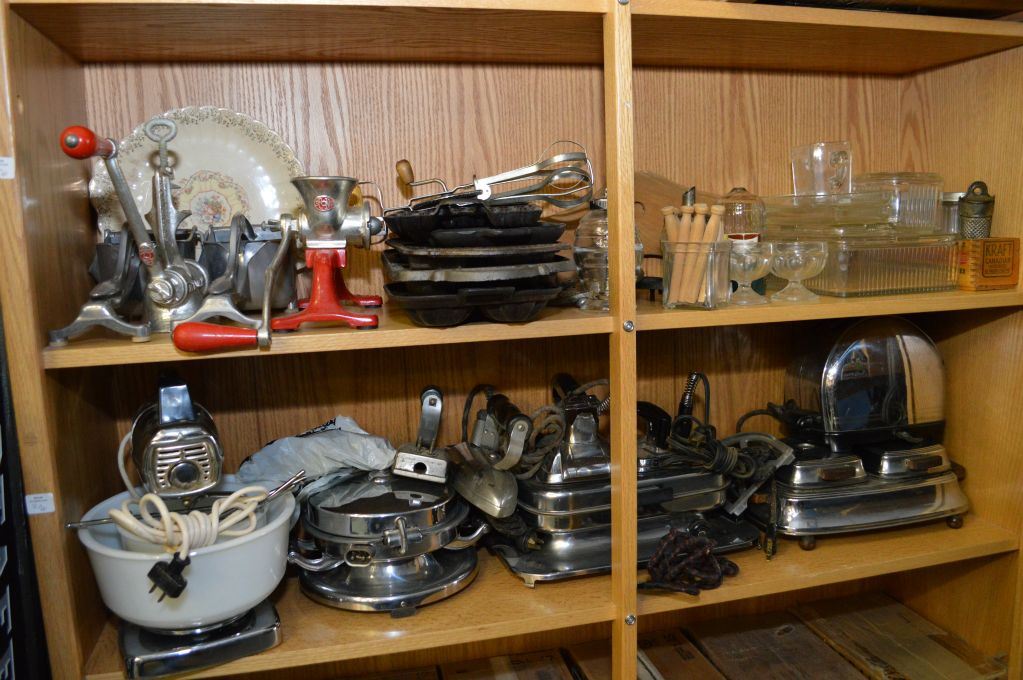 Two shelves of vintage kitchen collectibles including electric mixer ...