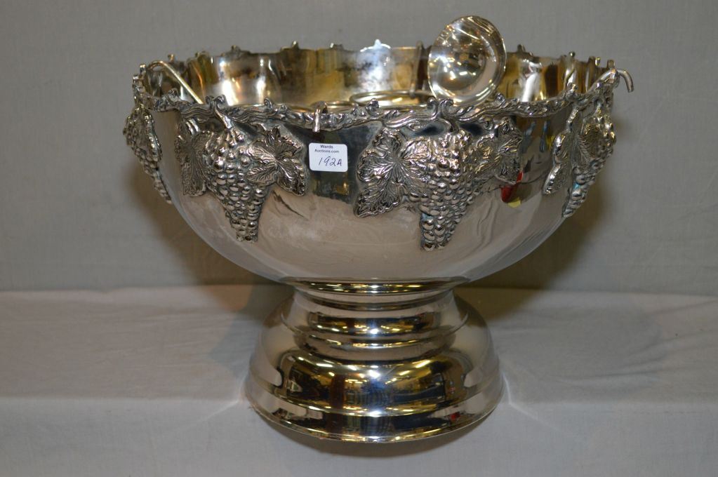 Large silver plate punch bowl with bottle holders and ice rack and ladle