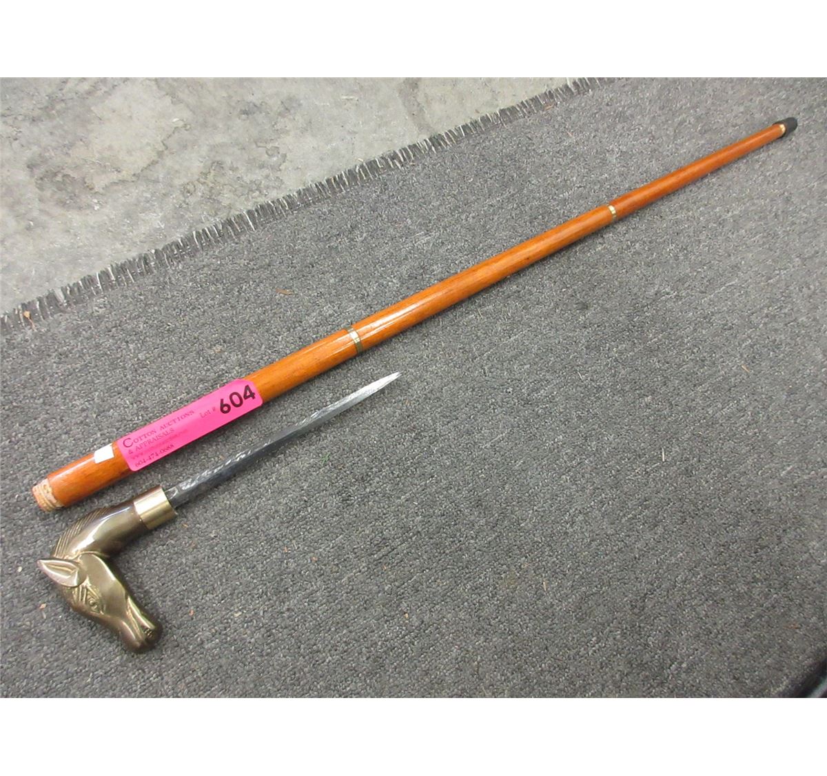 Sword cane with brass horse head handles