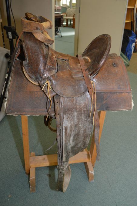 Antique Western Saddle w/hi back, needs restoration, c/w wood stand