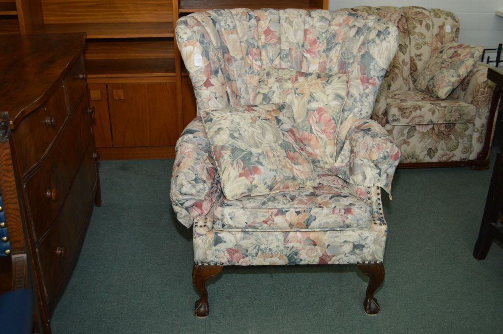 Channel back upholstered arm chair with carved ball and claw feet