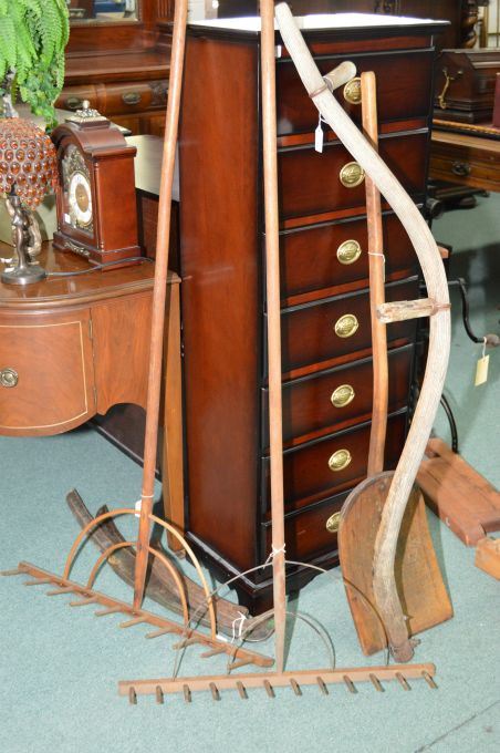 Collection of hand farm tools including grain shovel, straw racks ...
