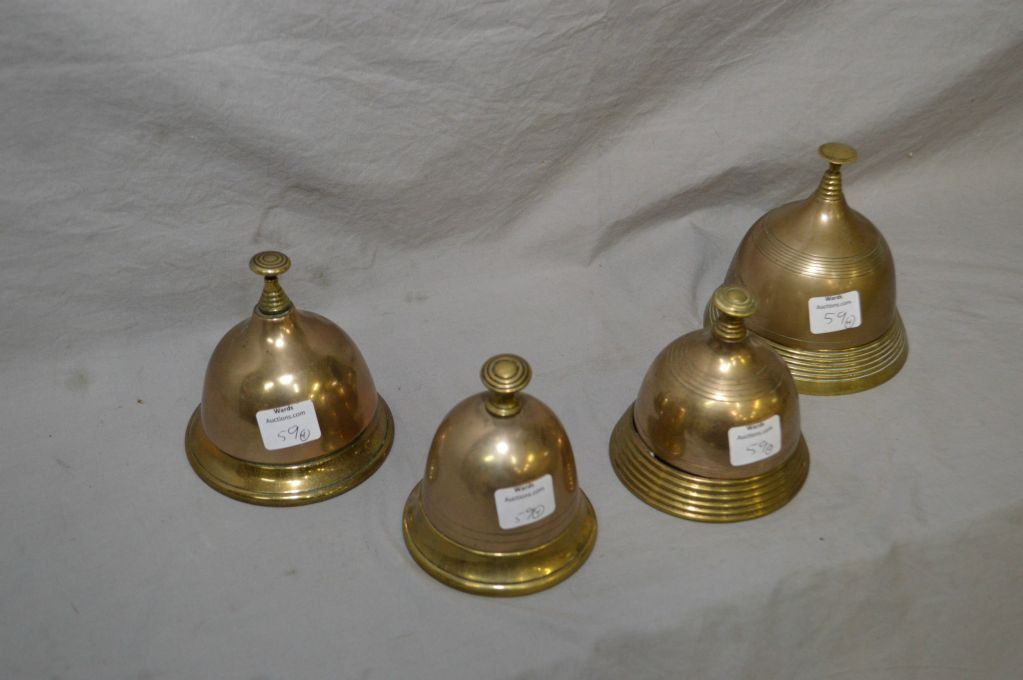 Four vintage brass counter bells, various graduated sizes