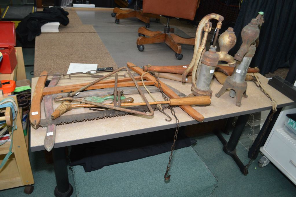 Selection of primitive collectibles including a signal triangle, saws ...