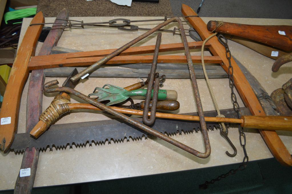 Selection of primitive collectibles including a signal triangle, saws ...