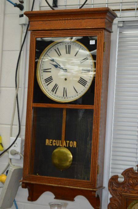 Antique Sessions regulator wall clock with visible pendulum