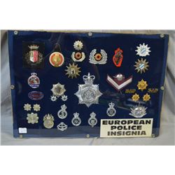Large framed selection of European police badges and insignia