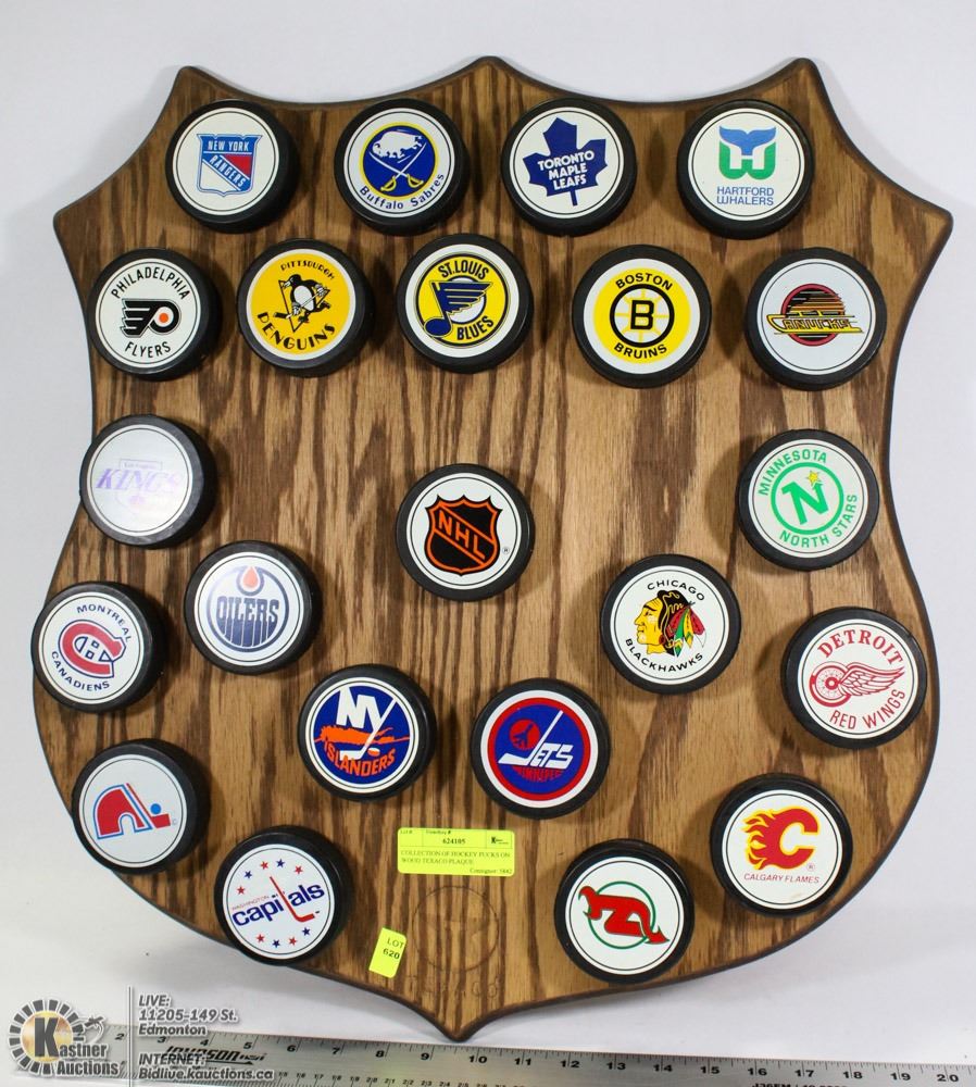 COLLECTION OF HOCKEY PUCKS ON WOOD TEXACO PLAQUE