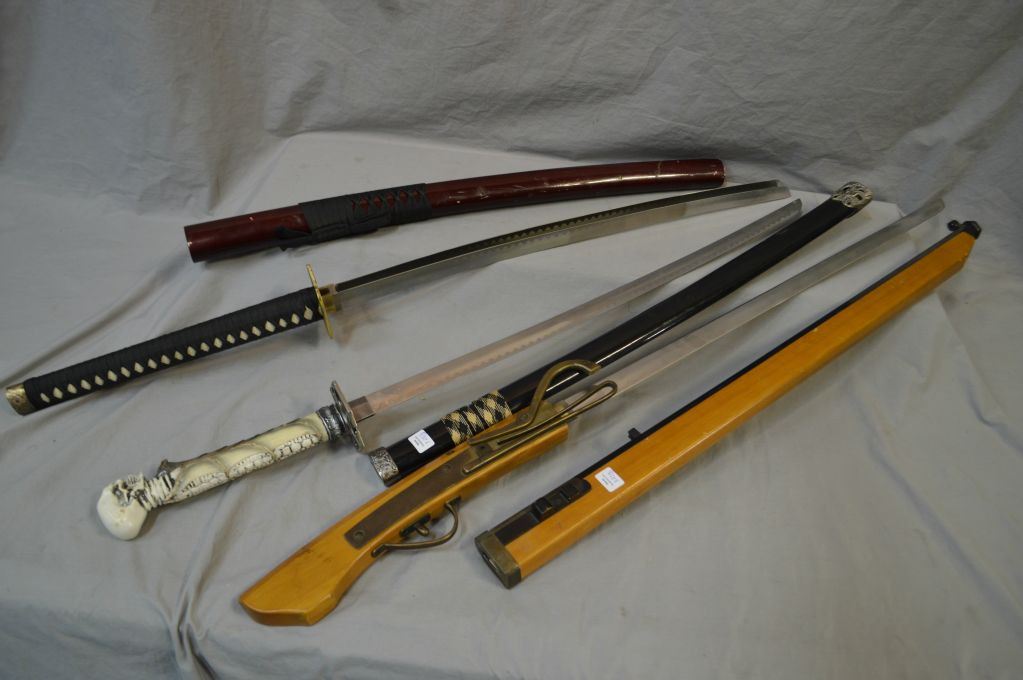 Three replica swords including shot gun motif sword and sheath ...