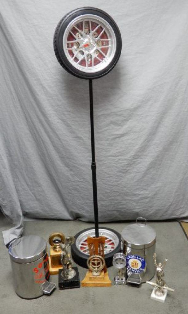 GROUP OF TROPHY'S, TRASH BINS & TIRE CLOCK LOCATION: LOWER LEFT