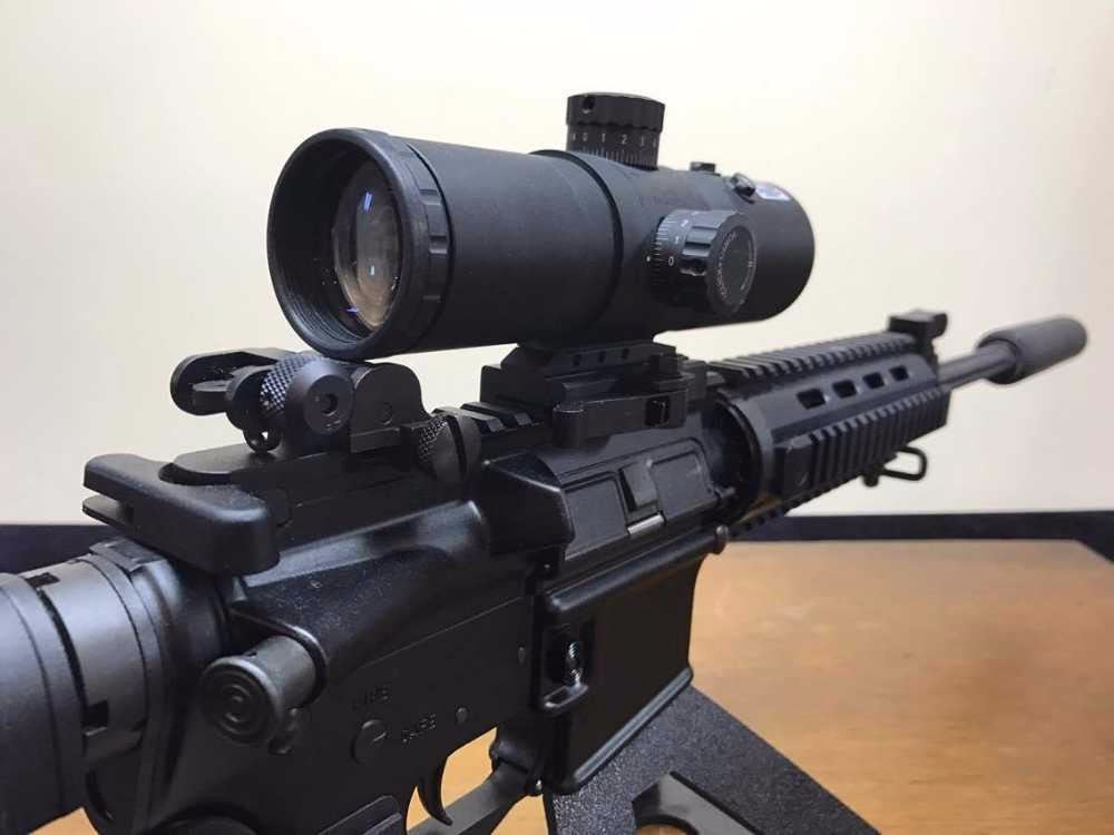 Bushmaster XM15 5.56 Fluted Barrel, Quad Rail Iron Sights P Sniper Scope