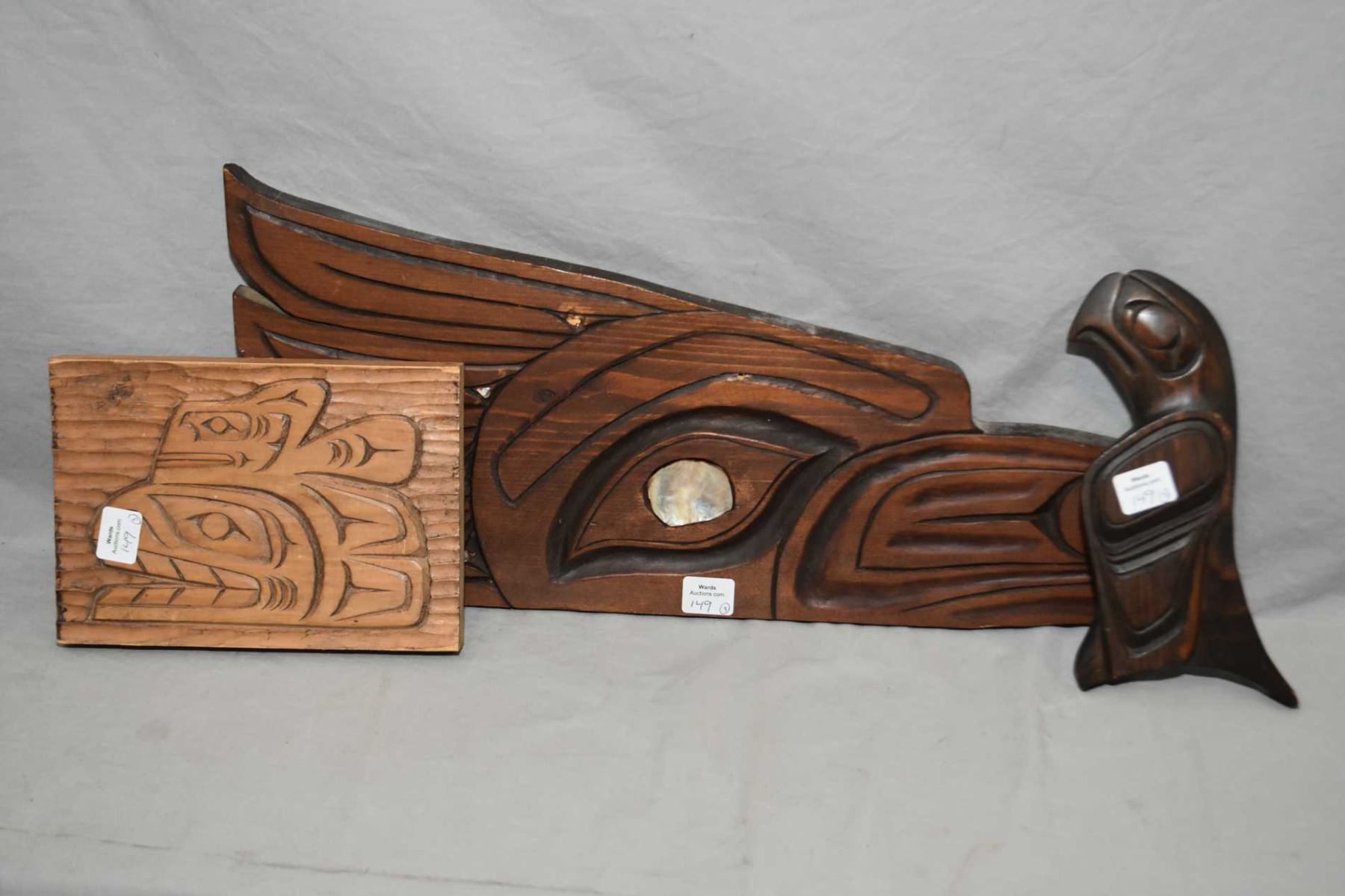 Selection of three West Coast Haida plaques including "Eagle Headress ...