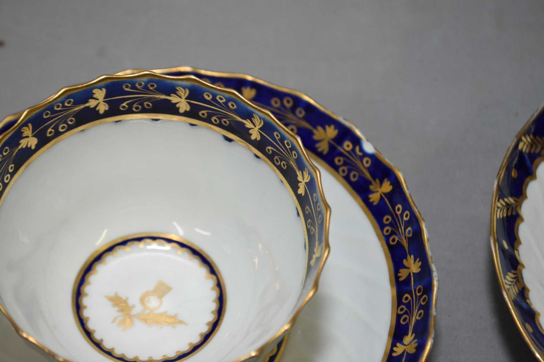 Two antique Worcester gilt edge cups and saucers including one handled ...