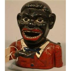 A cast iron "Jolly Nigger" money bank, typical form 6.5in....