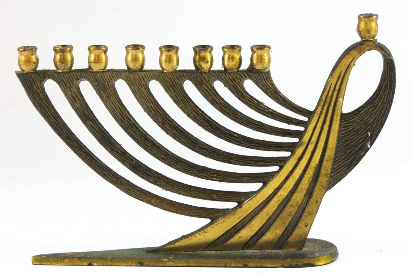 Old Israeli brass upright Hanukkah menorah lamp in the shape on an oil ...