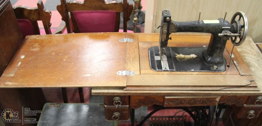 ANTIQUE RAYMOND TREADLE SEWING MACHINE.