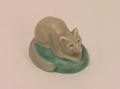 A Pilkington's Lancastrian model of a recumbent arctic fox, on green ...