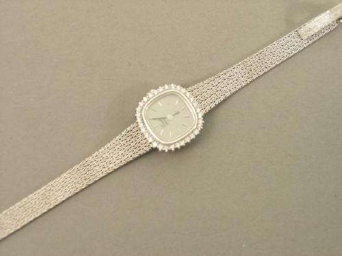 A lady's 18k white gold Emka wrist watch, with diamond set bezel and ...