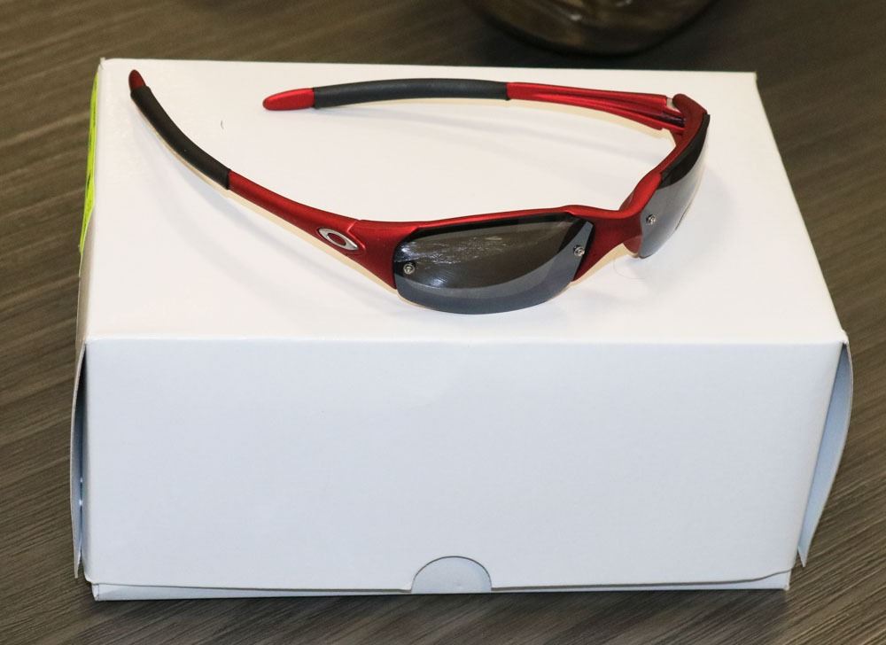 BOX OF OAKLEY STYLED SUNGLASSES WITH RED FRAMES