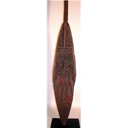 A RARE LAKE SENTANI PADDLE, of wood in slender fo