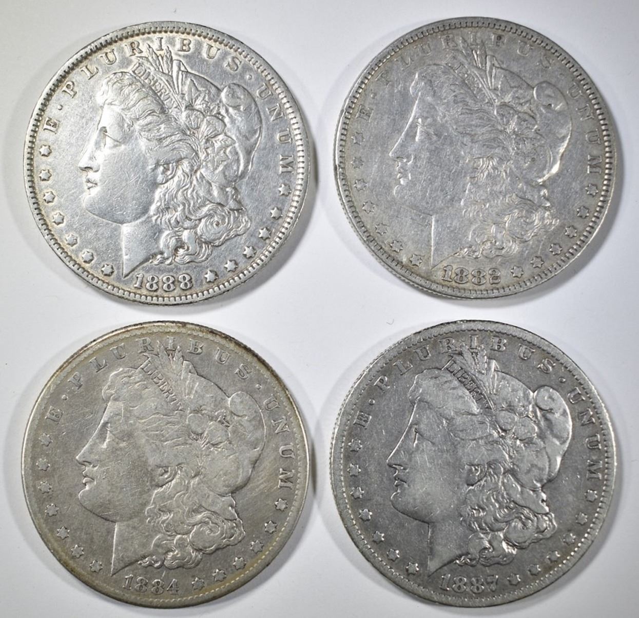 4 CIRC MORGAN DOLLARS 1882, 84-S, 87-O, 88-O.