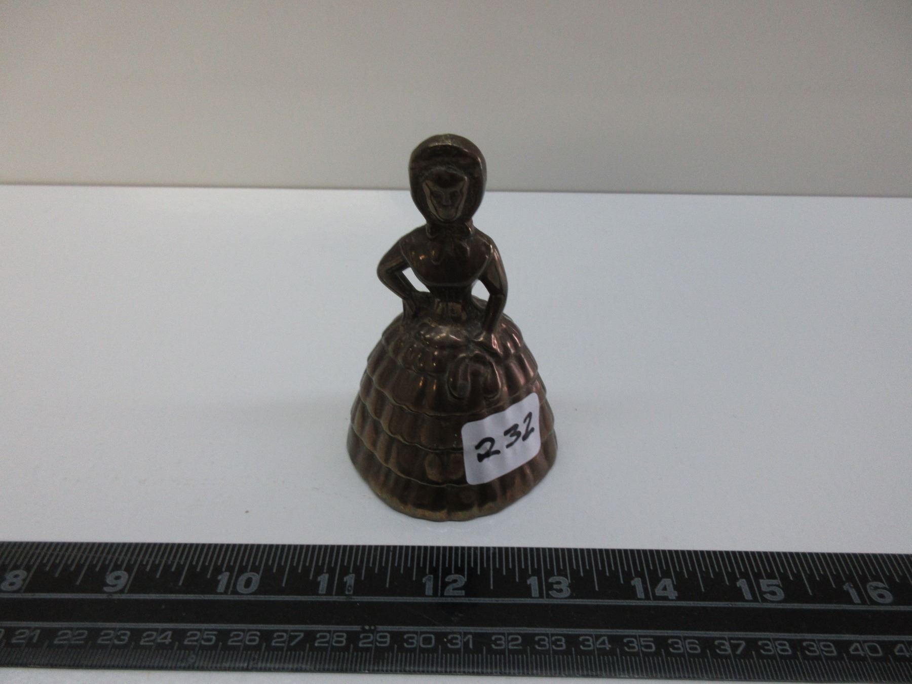 Brass Lady Bell and her feet are the ringer