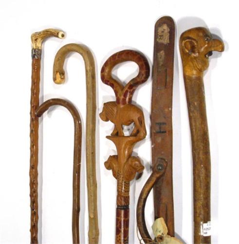 Collection of walking canes including a novelty figural cane, tribal ...