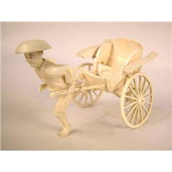 A JAPANESE CARVED IVORY RICKSHAW WITH M