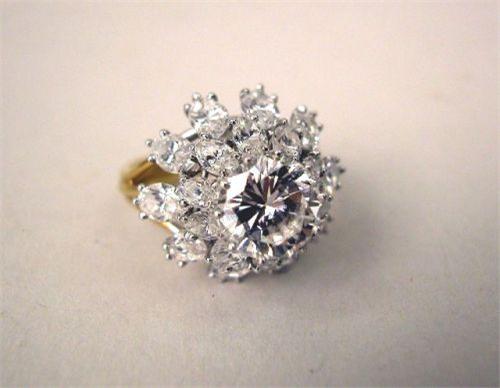 A CARTIER ROUND DIAMOND AND MARQUISE DIAMOND CLUSTER RING