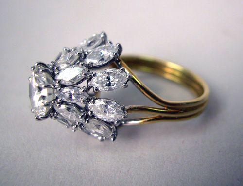 A CARTIER ROUND DIAMOND AND MARQUISE DIAMOND CLUSTER RING