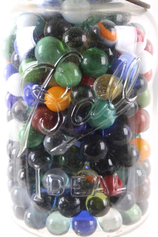 Collection of Various Sized Marbles In Mason Jars