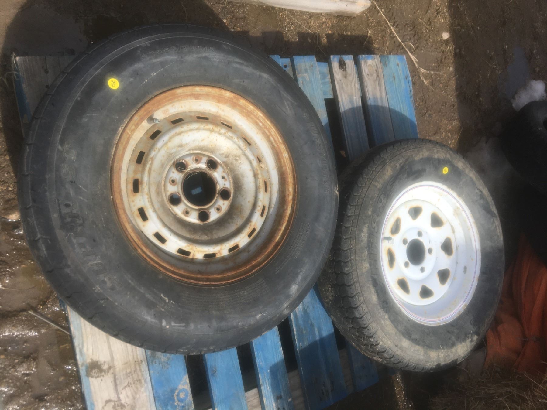 2-RIMMED TIRES (1) ST 205/75 D15, (1) ST 225/75 R15