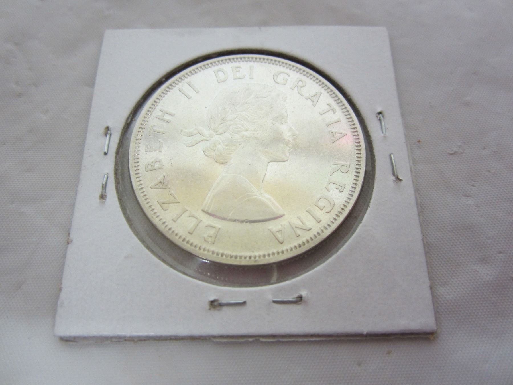 1964 CANADIAN SILVER DOLLAR Schmalz Auctions 1964-canadian-silver-dollar-schmalz-auctions