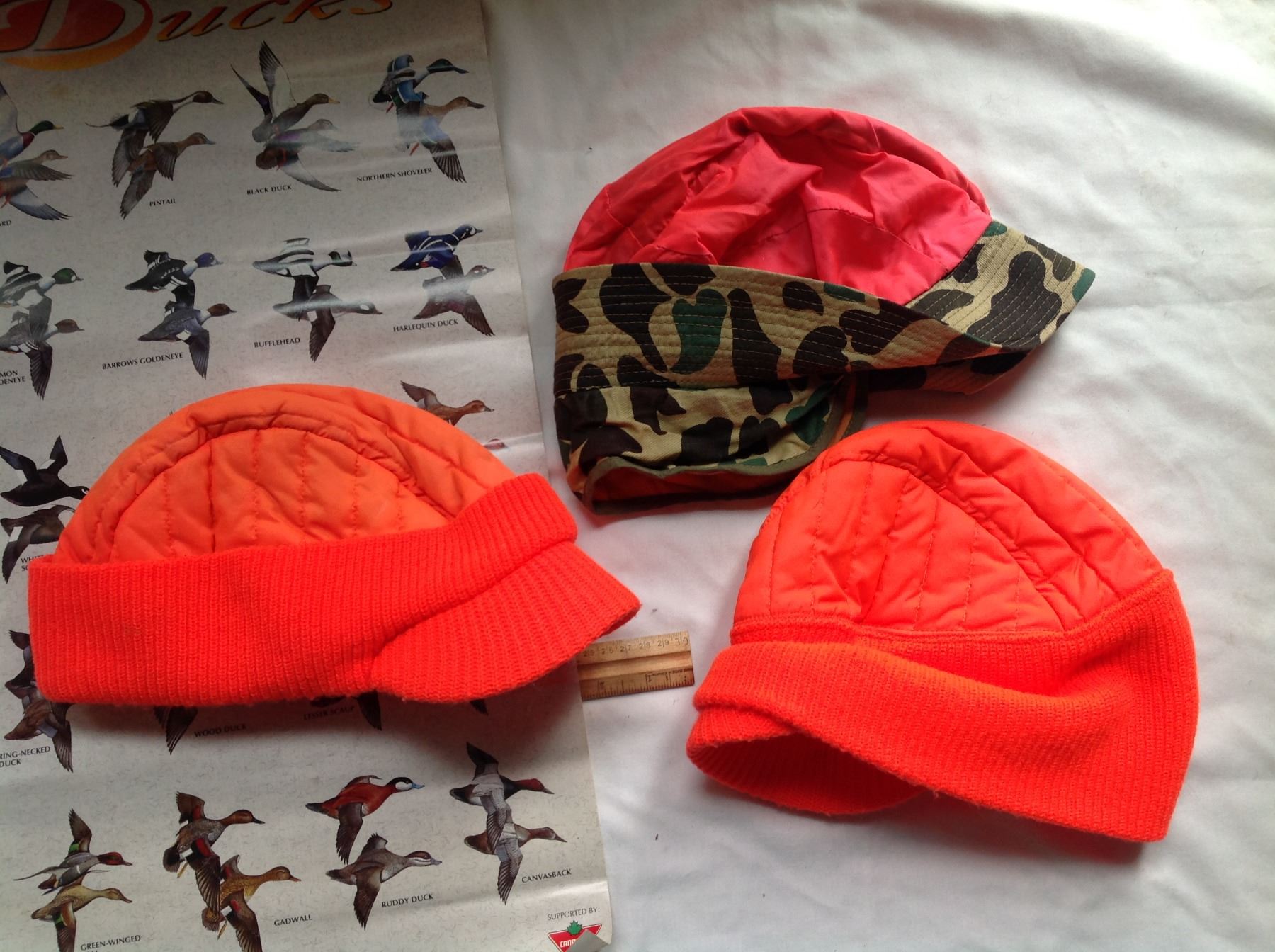 3 HUNTING HATS. 2 ORANGE/ 1 CAMOUFLAGE & ORANGE REVERSIBLE.