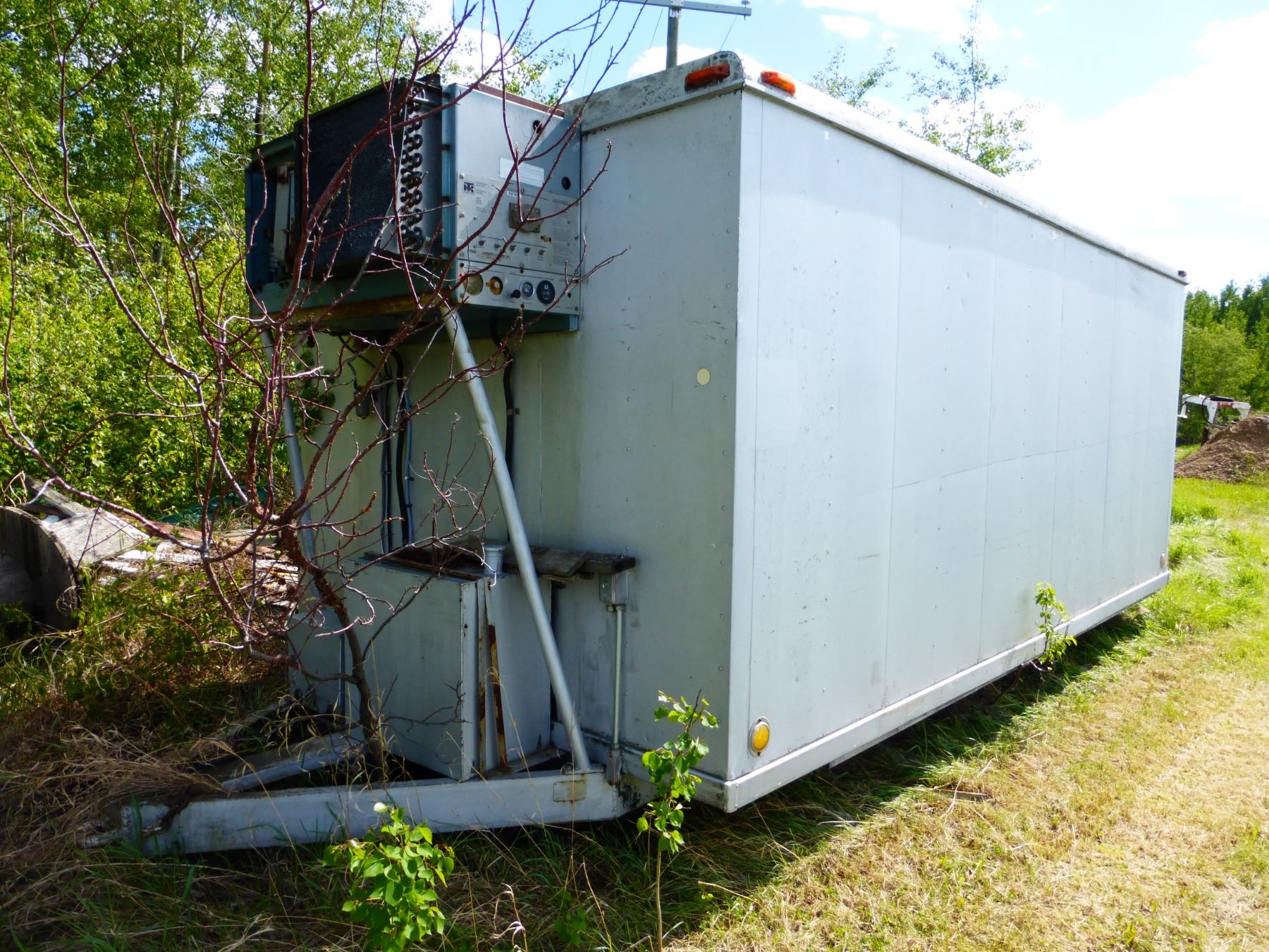GREY INSULATED STORAGE UNIT ON SKIDS WITH REEFER & CONTENTS