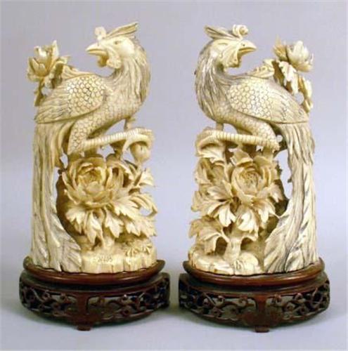 A PAIR OF CARVED IVORY BIRDS