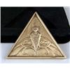 A BRONZE TRIANGULAR MEDALLION