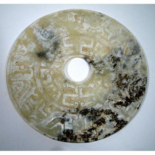 A ZHOU DYNASTY STYLE JADE KU-PI DISC,