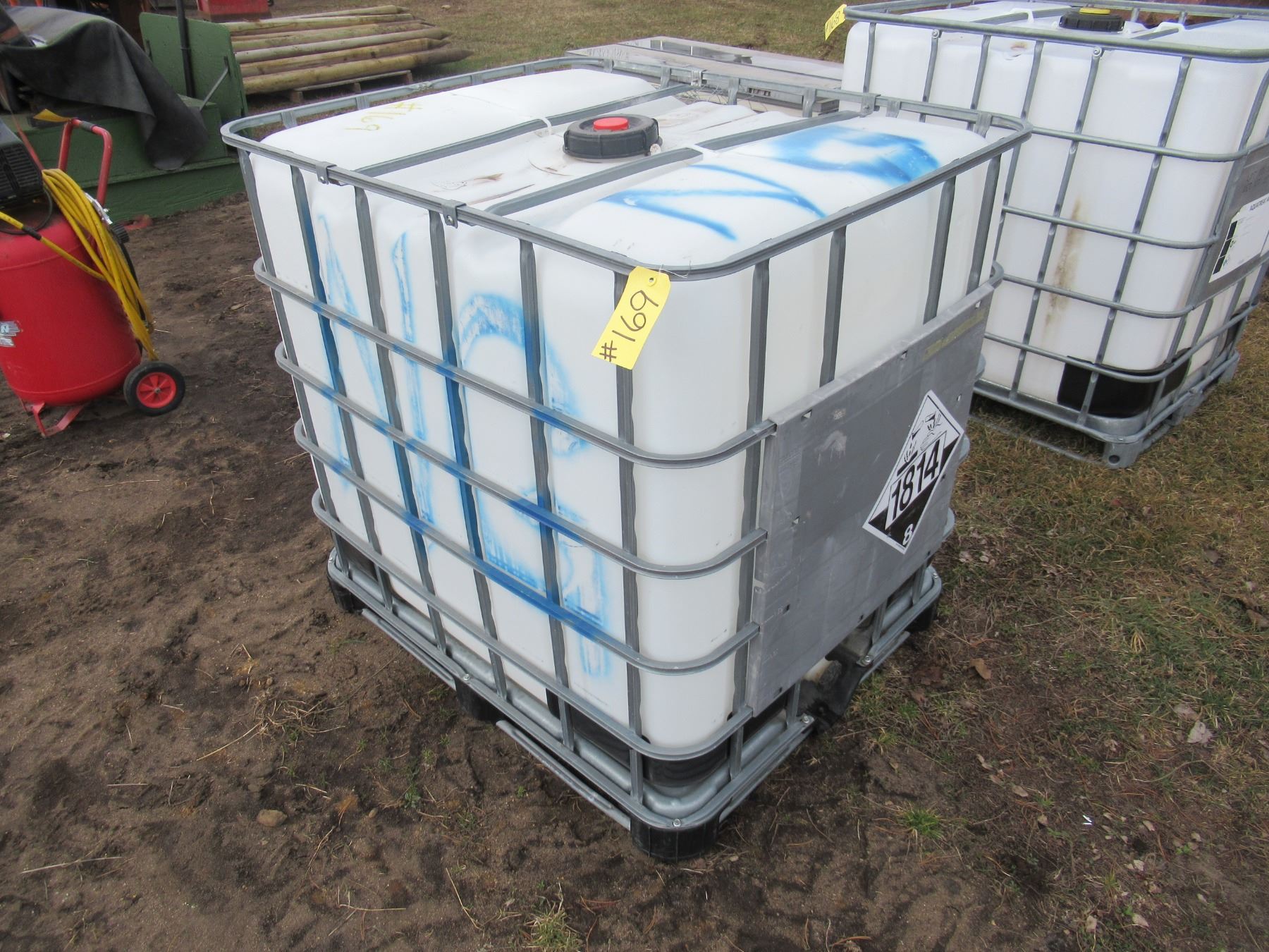 250 GALLON POLY TANK IN CAGE