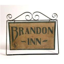 A PAINT-DECORATED WROUGHT IRON SIGN