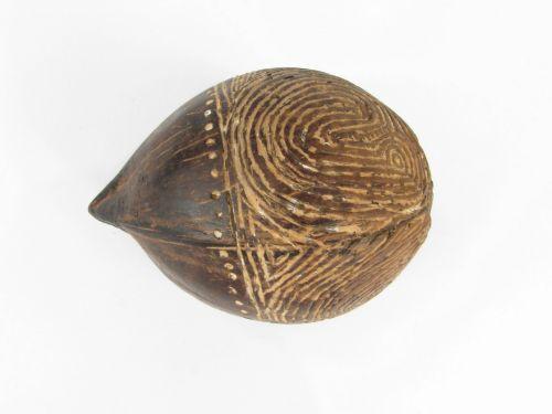 A MARAPAI RATTLE, of coconut shell incised wi