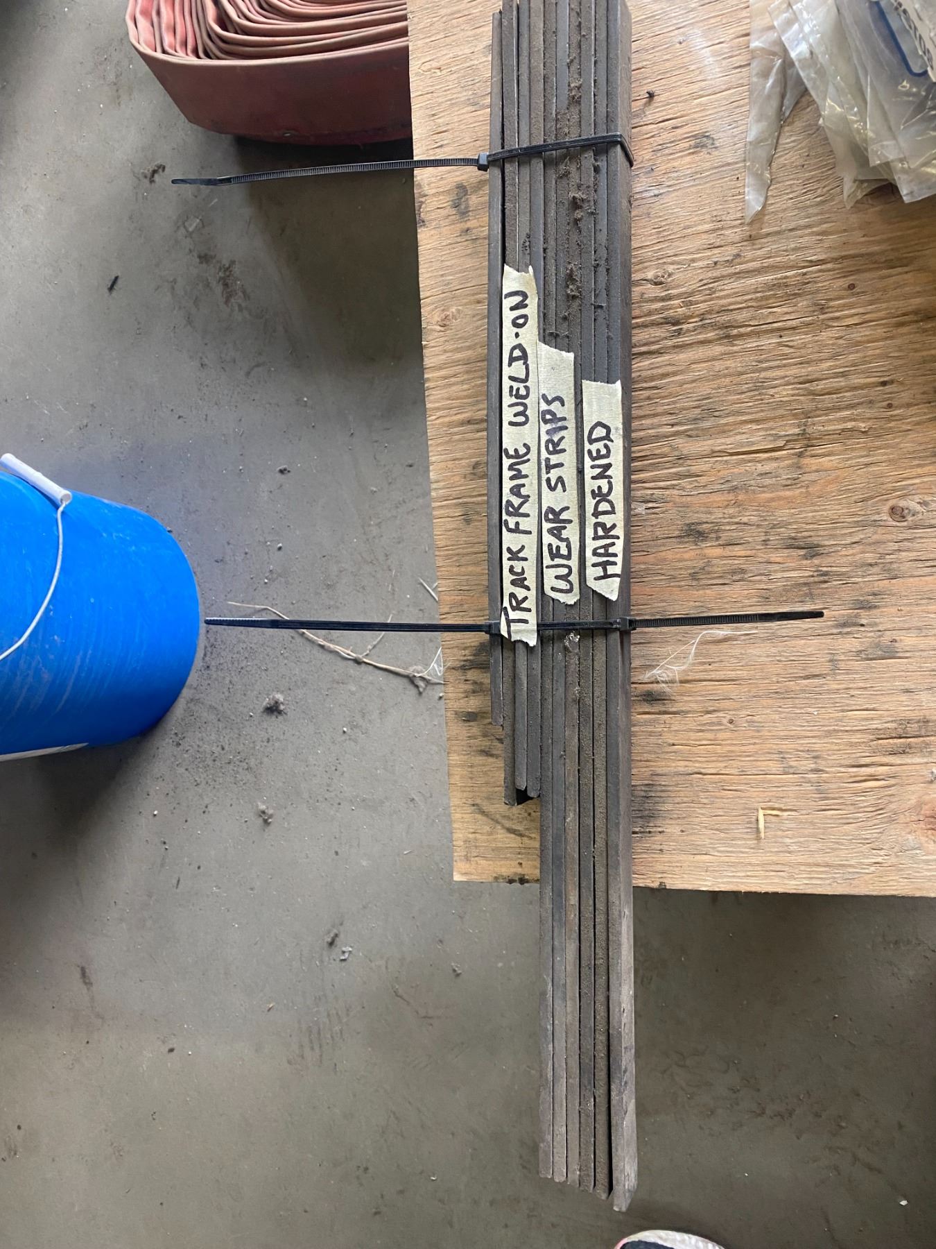 Track frame weld on wear strips hardened