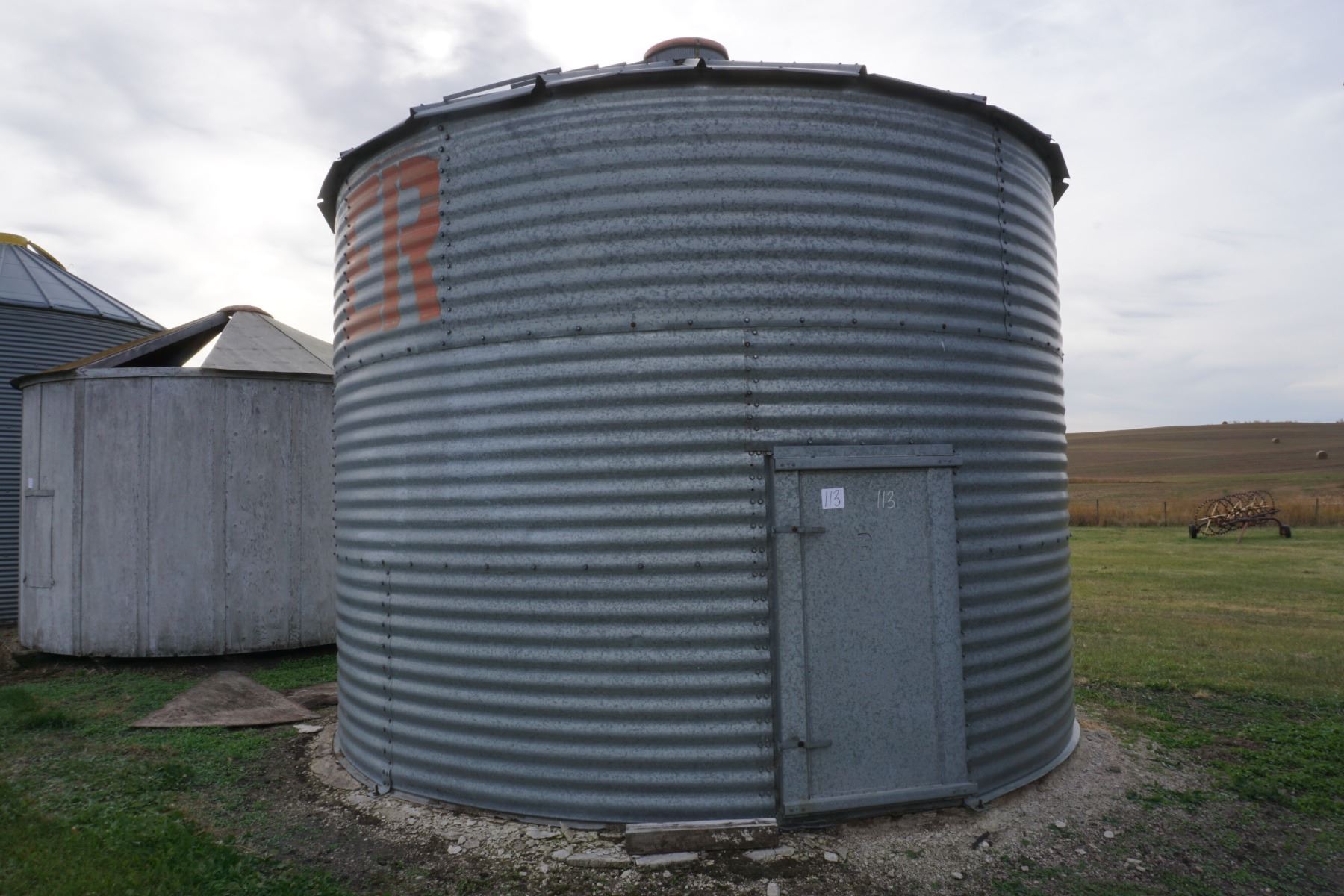 Butler Bin on cement (approx 2500 bushel) Approx 75bushel of wheat in bin