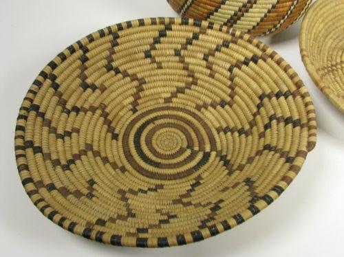 THREE WEST AFRICAN BASKETS, of woven polychro