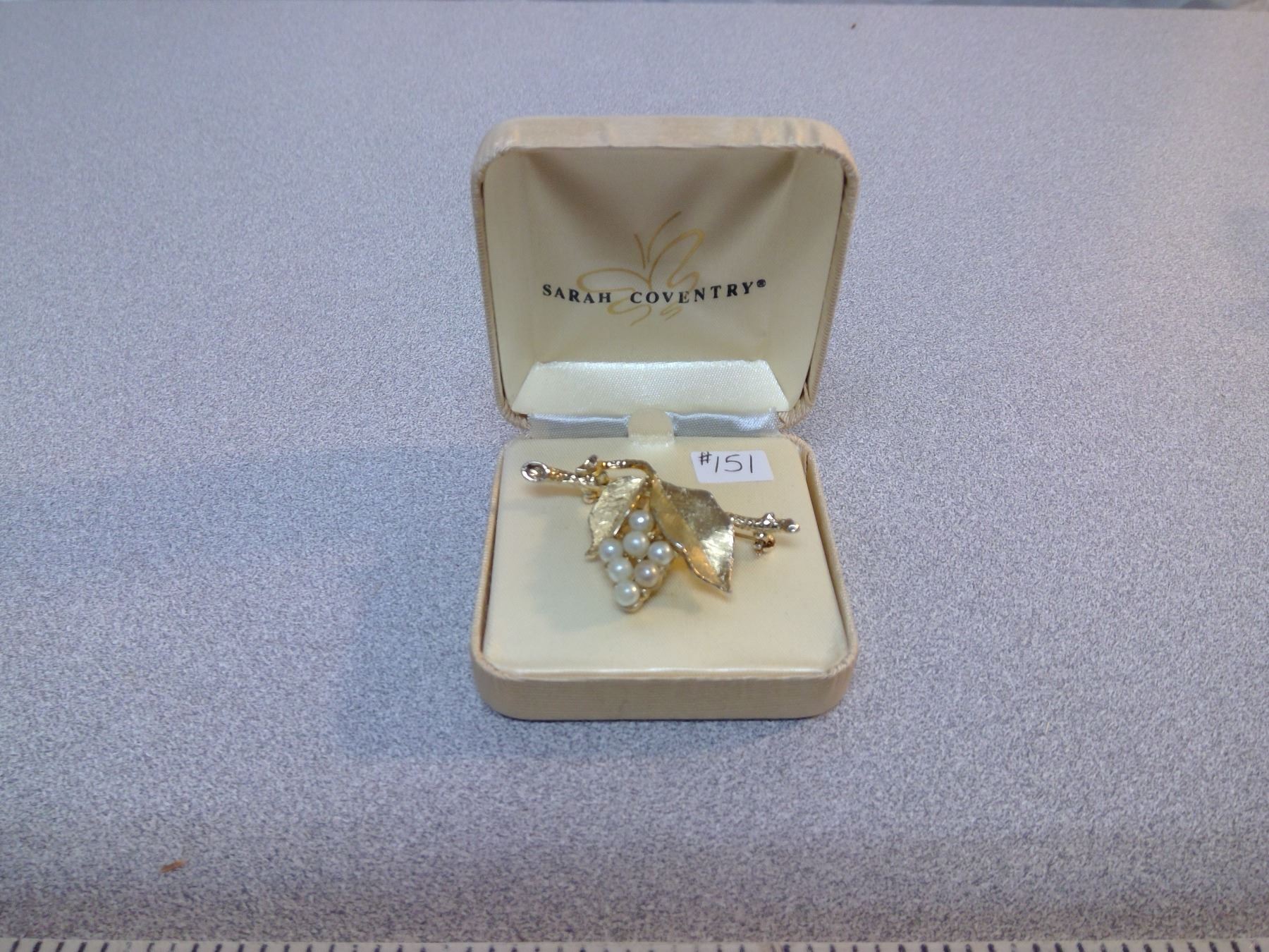 151. Sarah Coventry gold tone and faux pearl broach in Sarah Coventry box