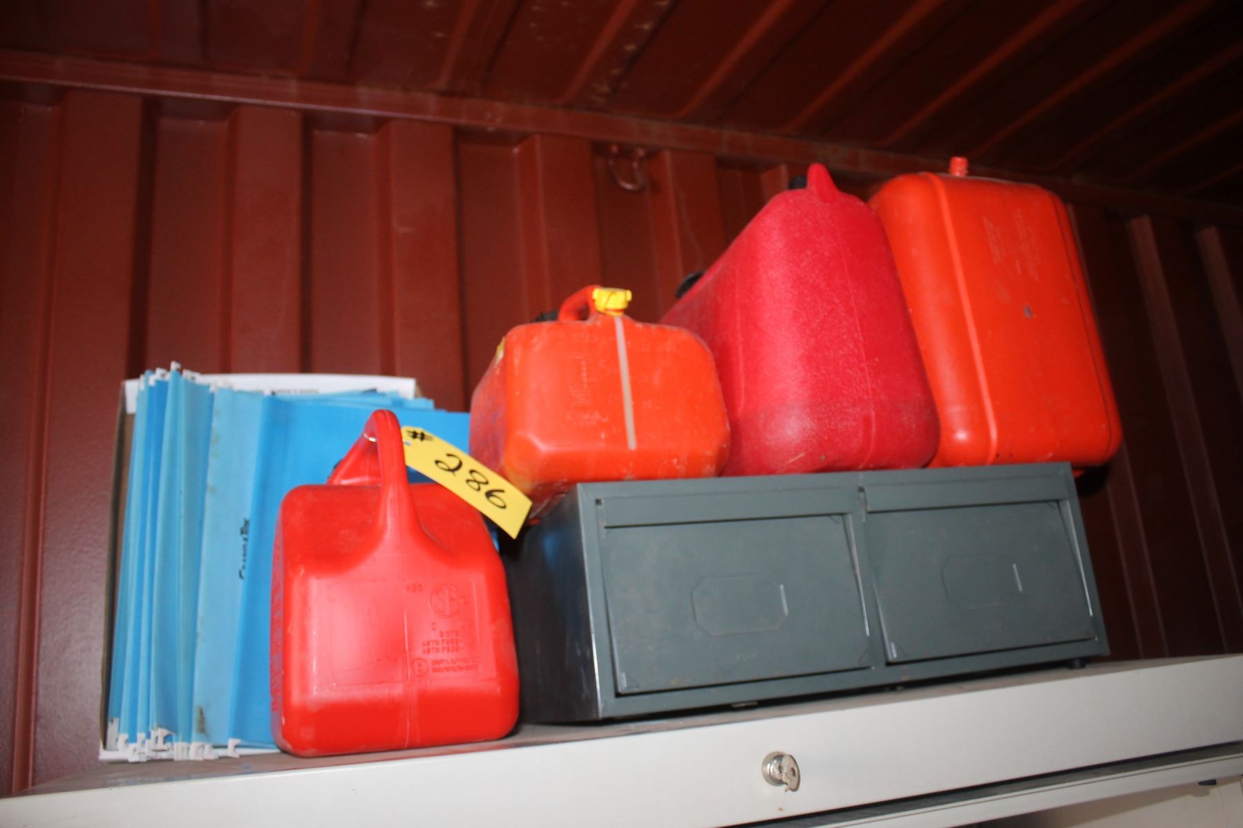 4 JERRY CANS AND A GREY CABINET