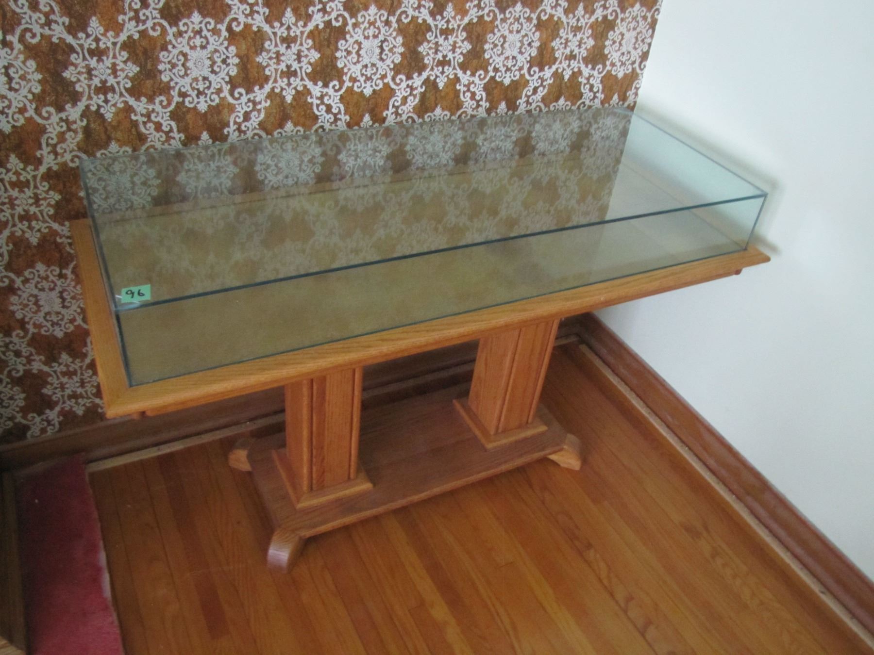 glass topped display table approximately 51 long bye 22 wide X 32 tall