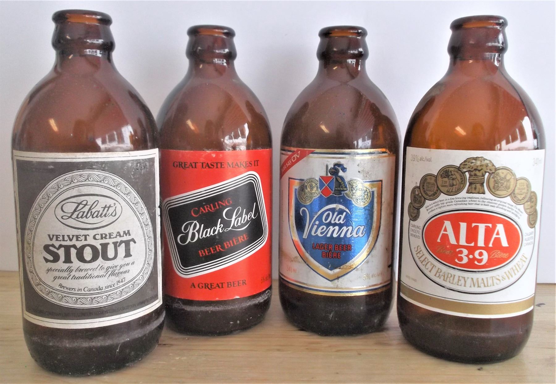Four Stubby Beer Bottles