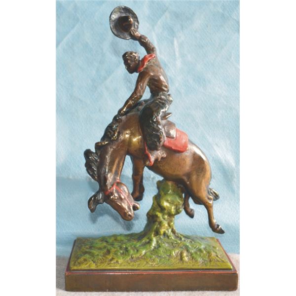 colored bronze of a bucking horse & rider