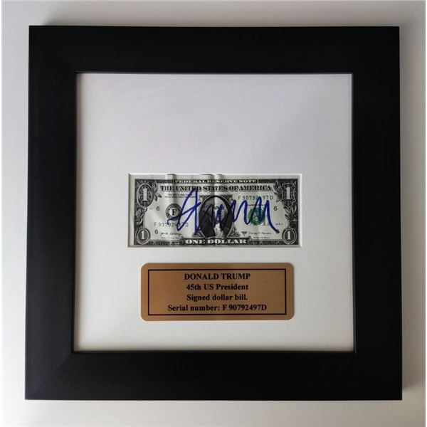 Donald Trump signed dollar bill.
